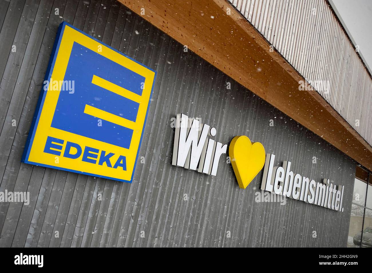 EDEKA company logo with the slogan WE LIVE FOOD at a branch, market in ...