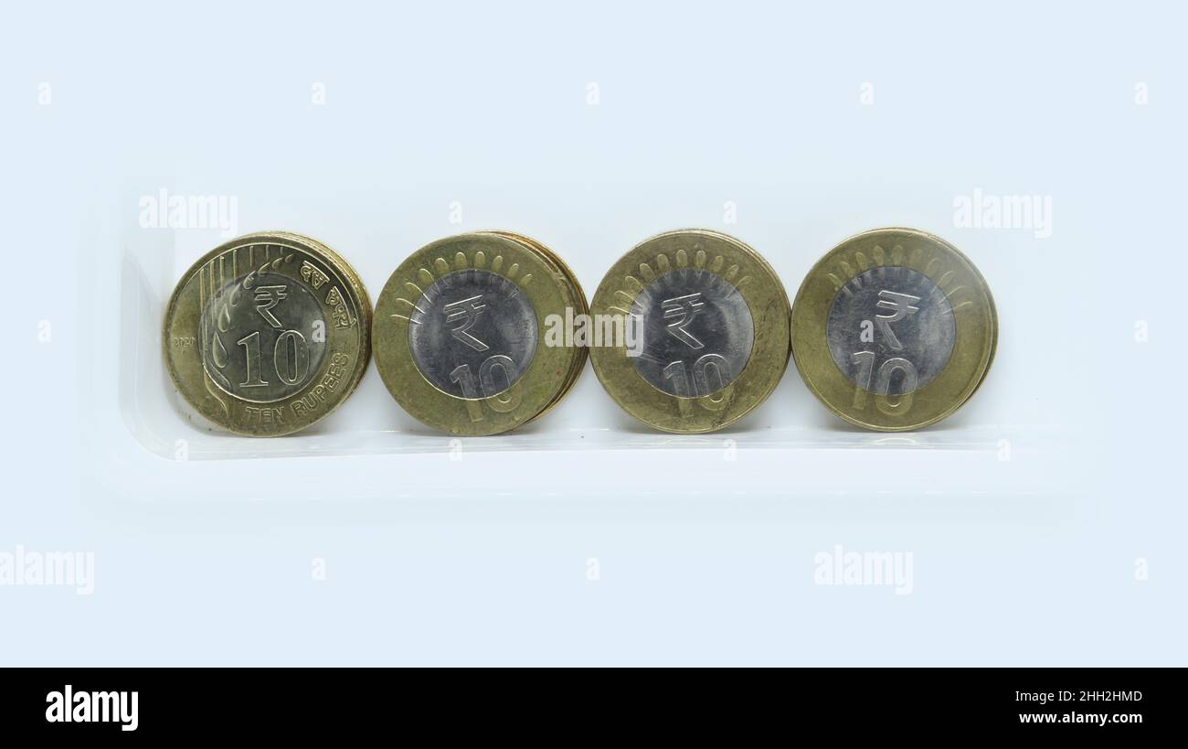Indian Rupee Coins. Ten rupee coins stacked in stacks. On a white ...