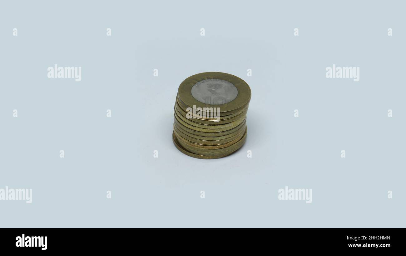 Indian Rupee Coins. Ten rupee coins stacked in stacks. On a white ...