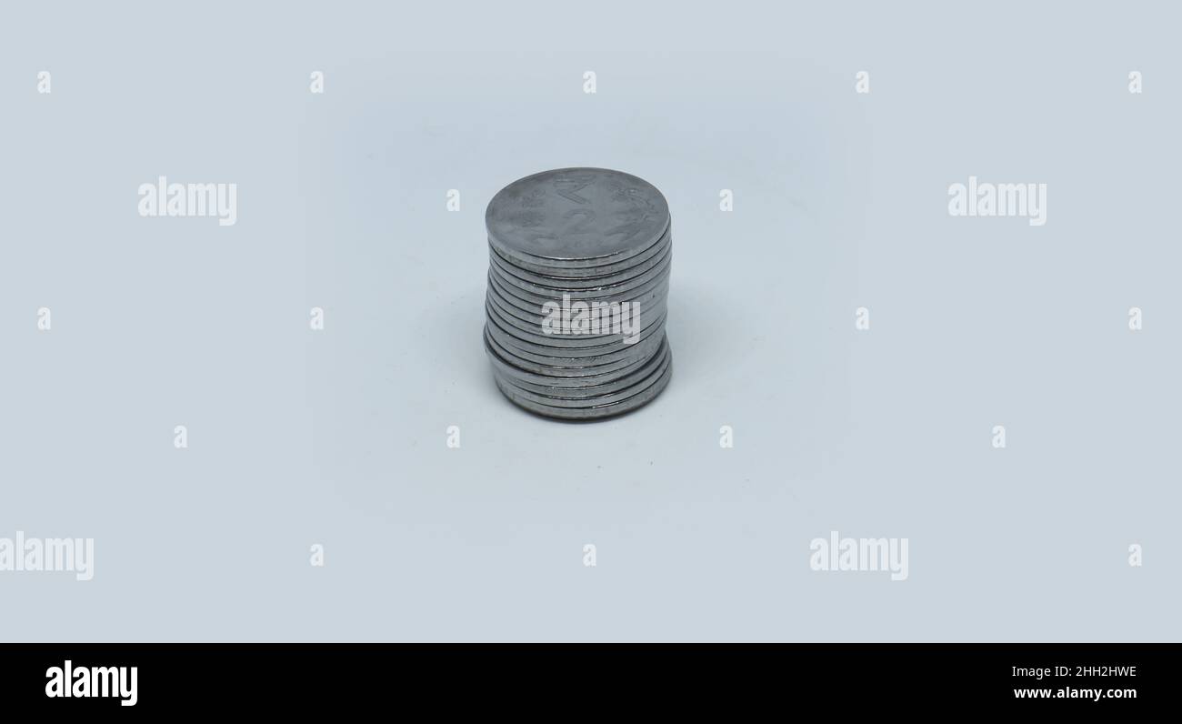 Indian Rupee Coins. Two rupee coins stacked in stacks. On a white ...
