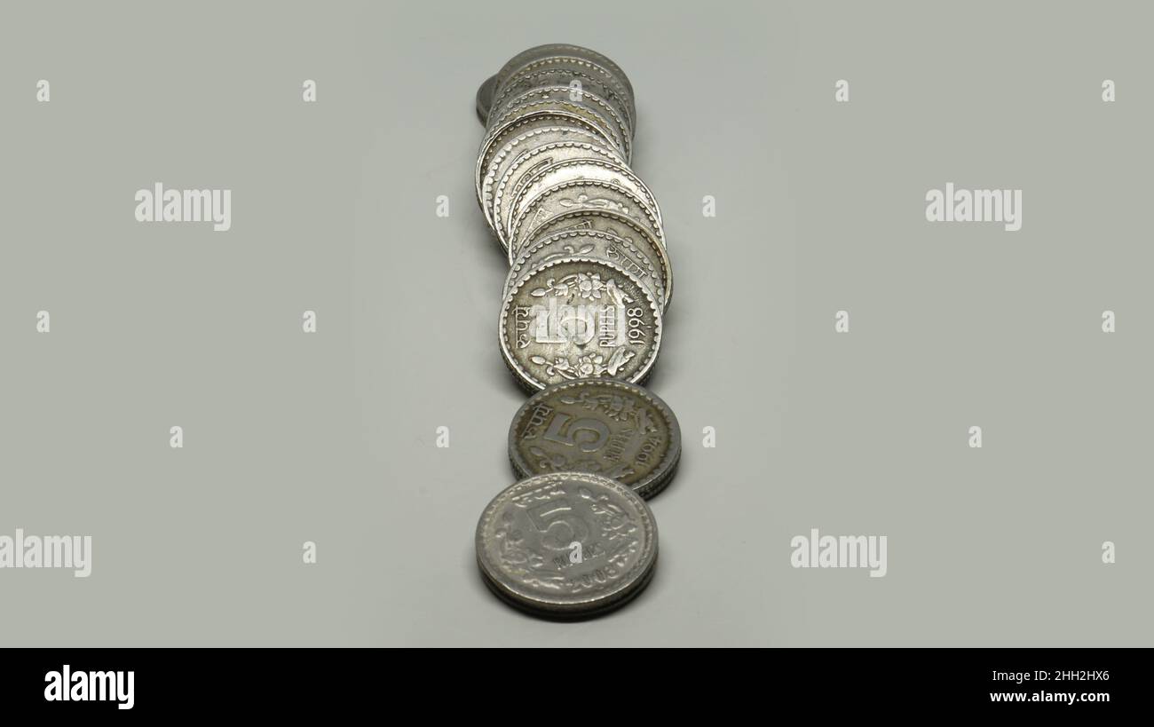Indian Rupee Coins. Five ten rupee coins stacked in stacks. On a white ...