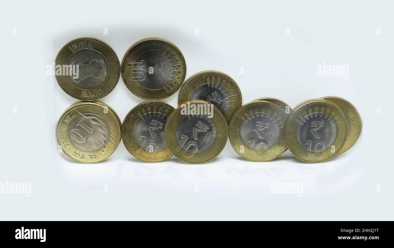 Pile of Indian Rupee Coins. Ten rupee coins stacked in stacks. On a ...