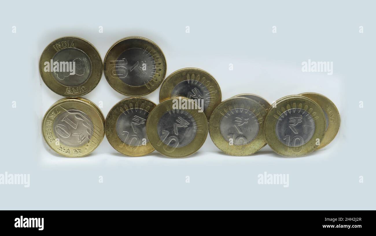 Pile of Indian Rupee Coins. Ten rupee coins stacked in stacks. On a ...