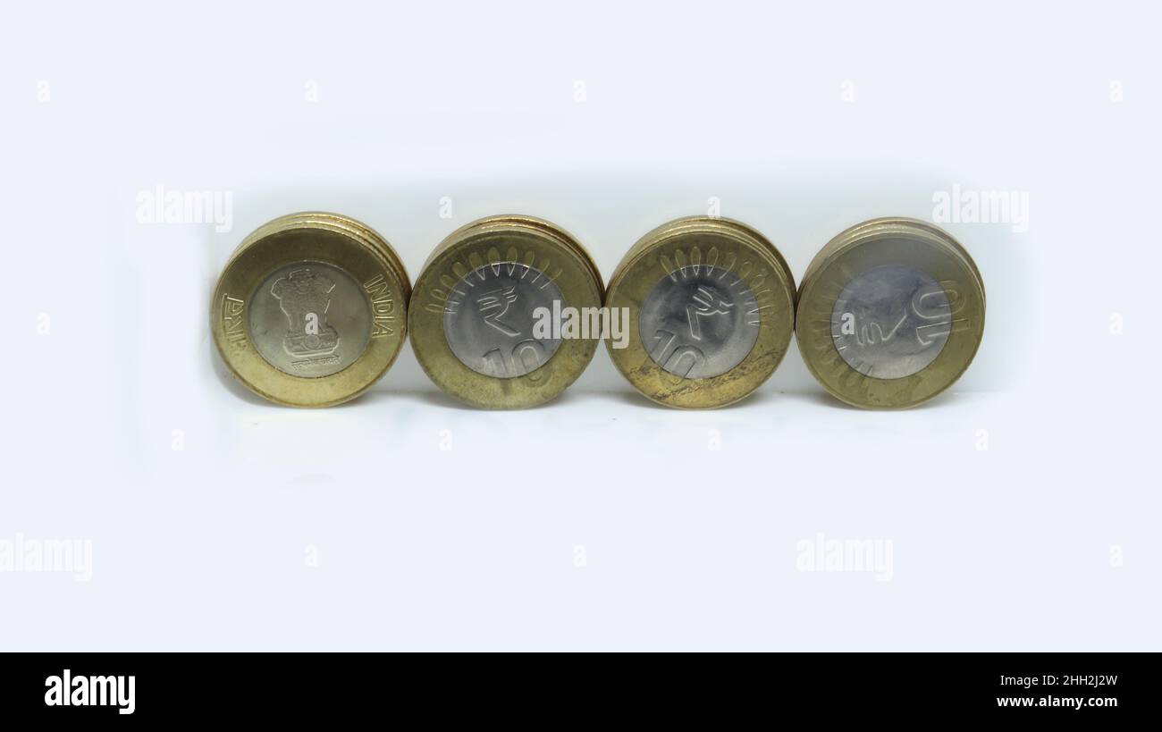 Indian Rupee Coins. Ten rupee coins stacked in stacks. On a white ...