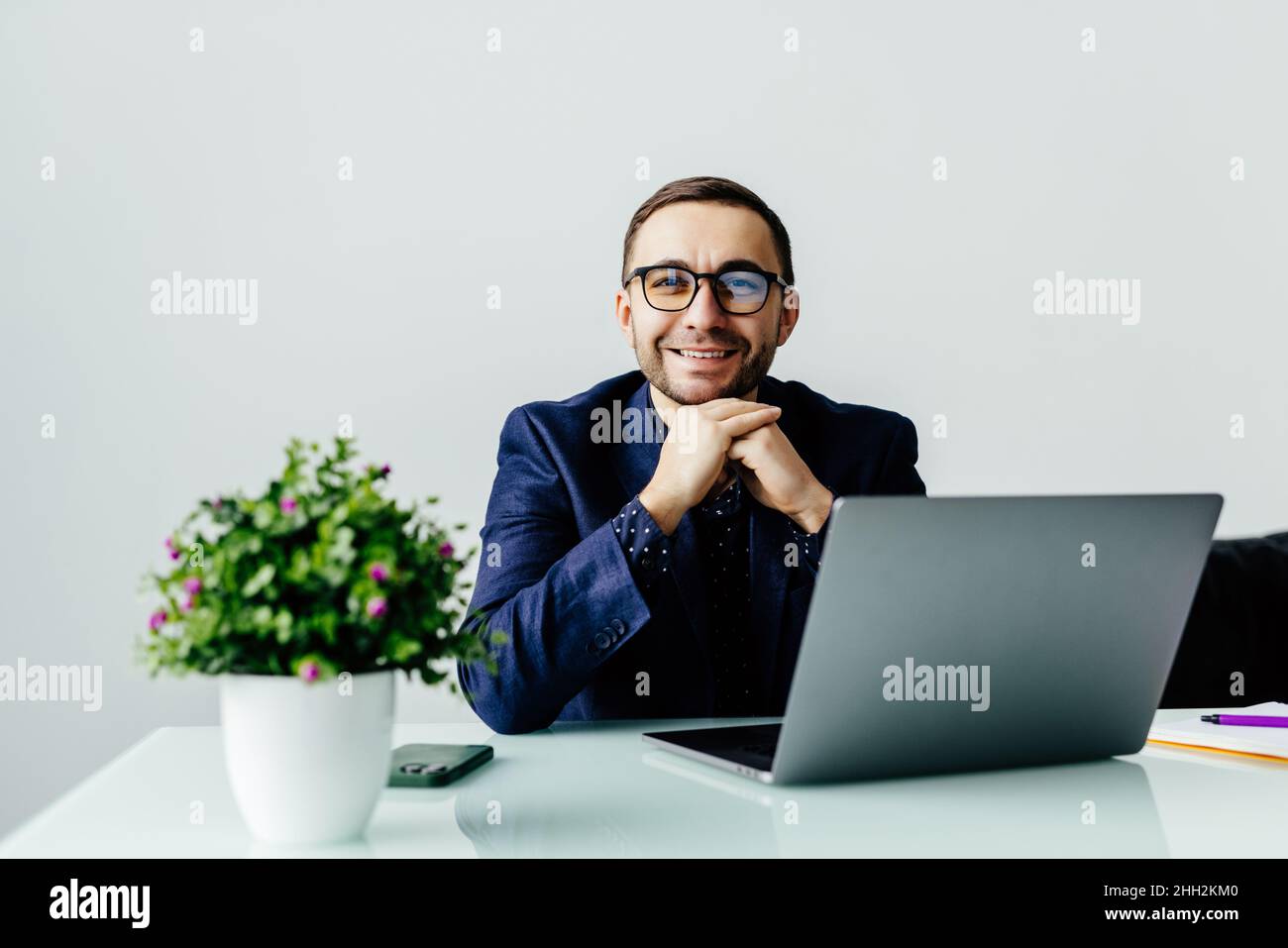 Young dreamy businessman in suit thinking of business vision outlook ...