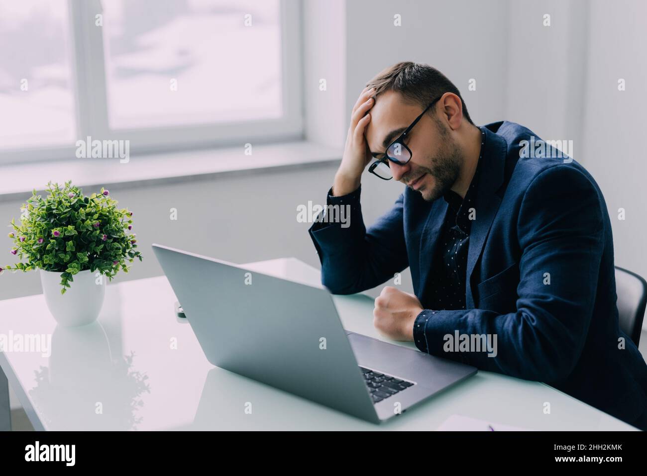 Portrait of upset businessman at desk in office. Businessman being ...
