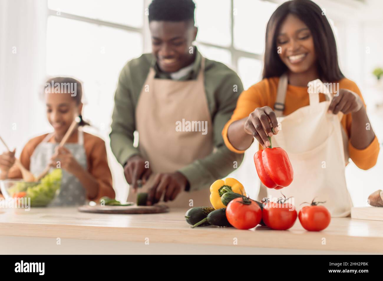 African Family Cooking, Mother Holding Bell Pepper In Modern Kitchen ...