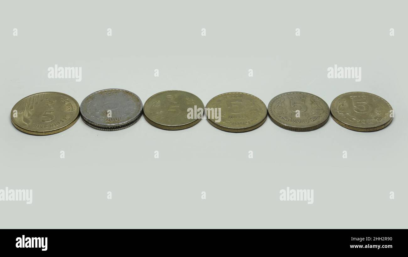 Indian Rupee Coins. Six five rupee coins in row wise. On a white ...