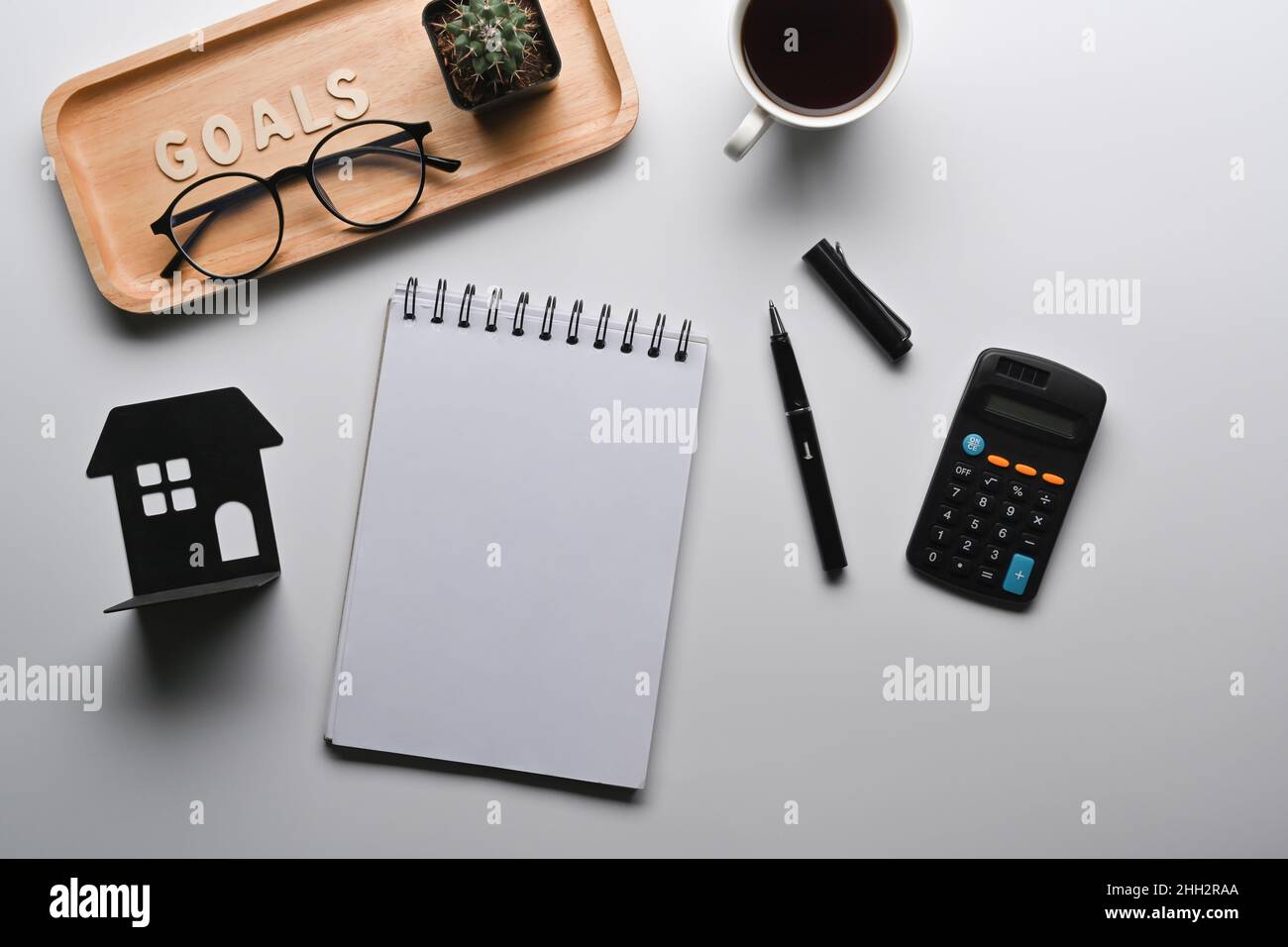 Notebook, house model and calculator on white background. Real estate ...