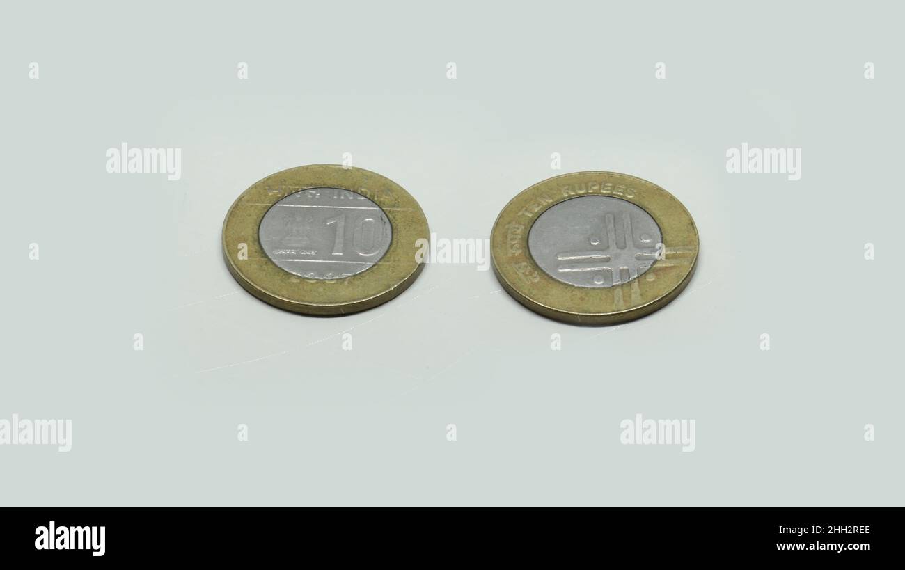 old Indian Rupee Ten Rupees cross symbol Coins. On a white background ...