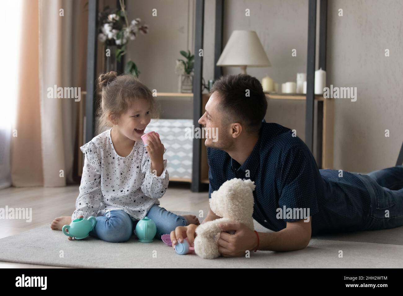 Happy bonding two generations family playing toys at home Stock Photo ...