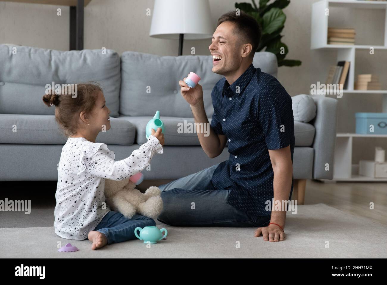 Adorable little child girl playing with laughing father Stock Photo - Alamy