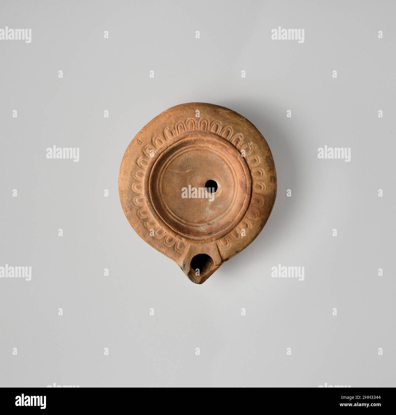 Terracotta oil lamp Roman, Cypriot Plain concave discus with off-center ...