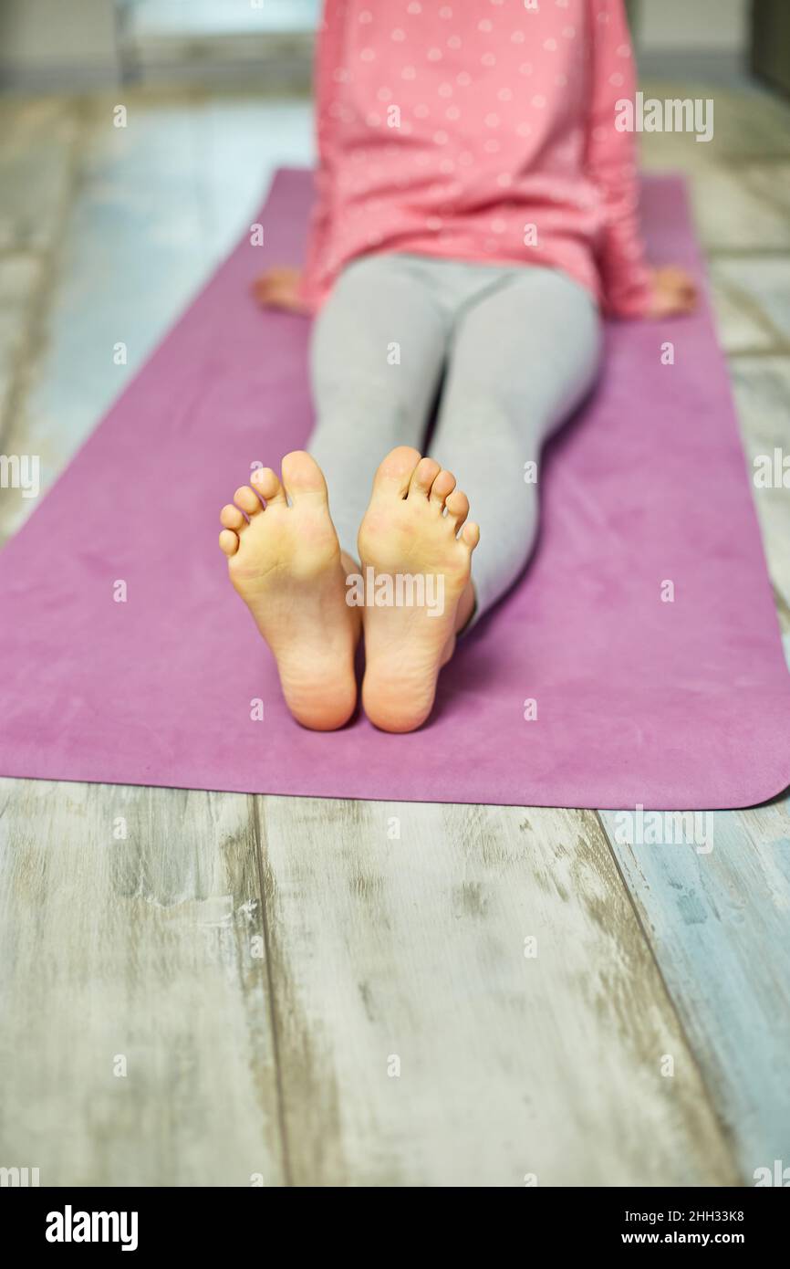 Close up of feet leg Little girl doing stretching exercises, practicing ...