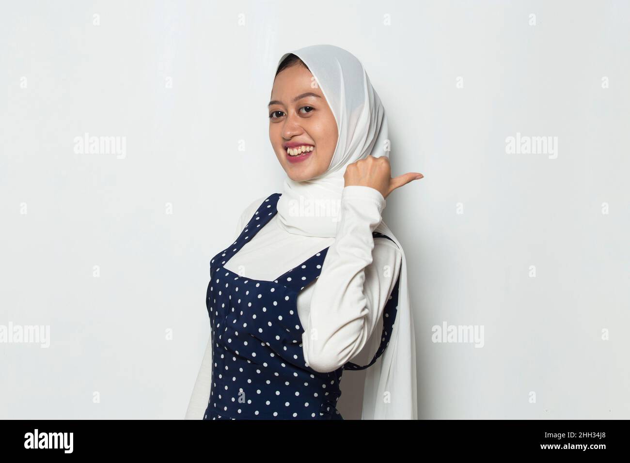 asian muslim woman pointing with fingers to different directions. Copy ...