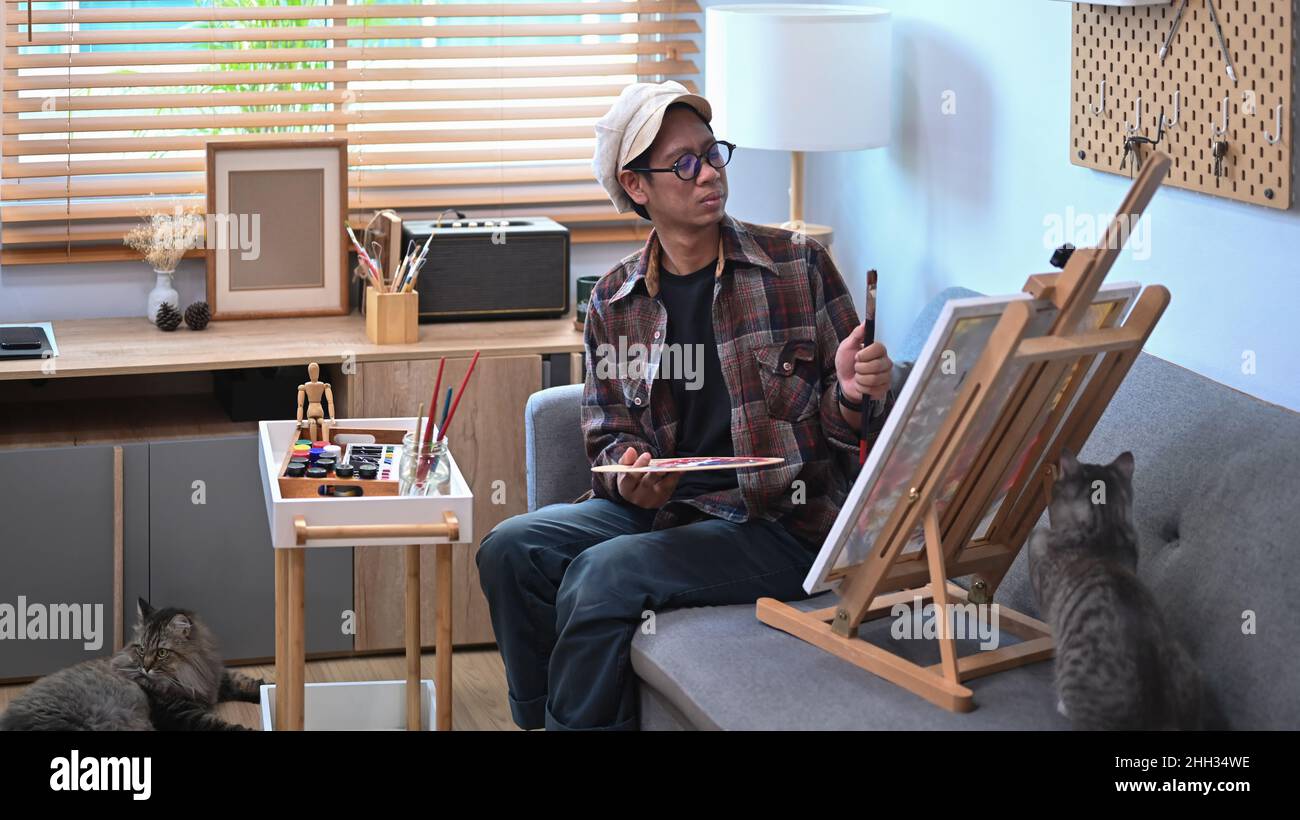 Asian male artist painting picture hi-res stock photography and images ...