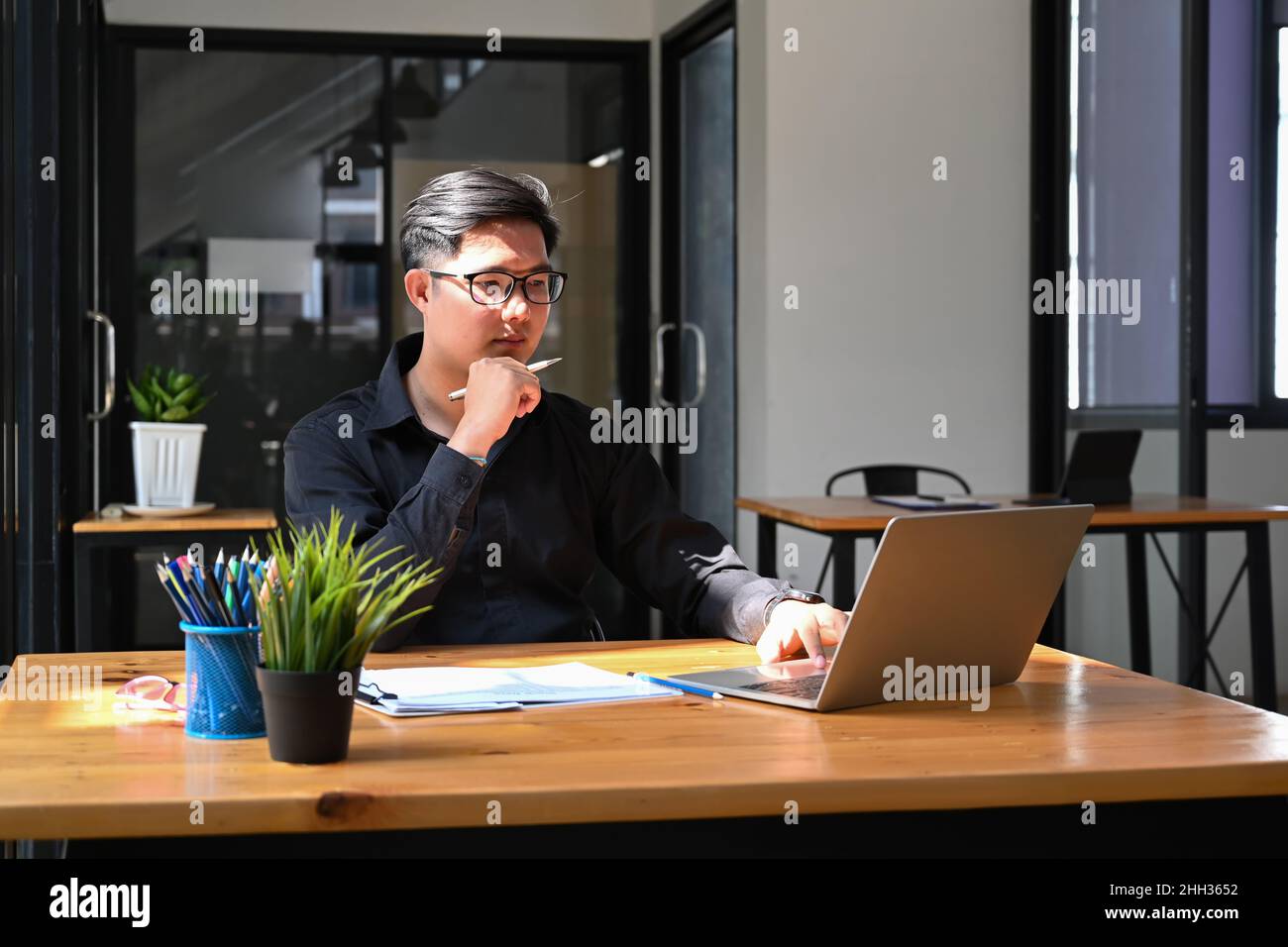 Successful businessman working with computer laptop at his workplace ...