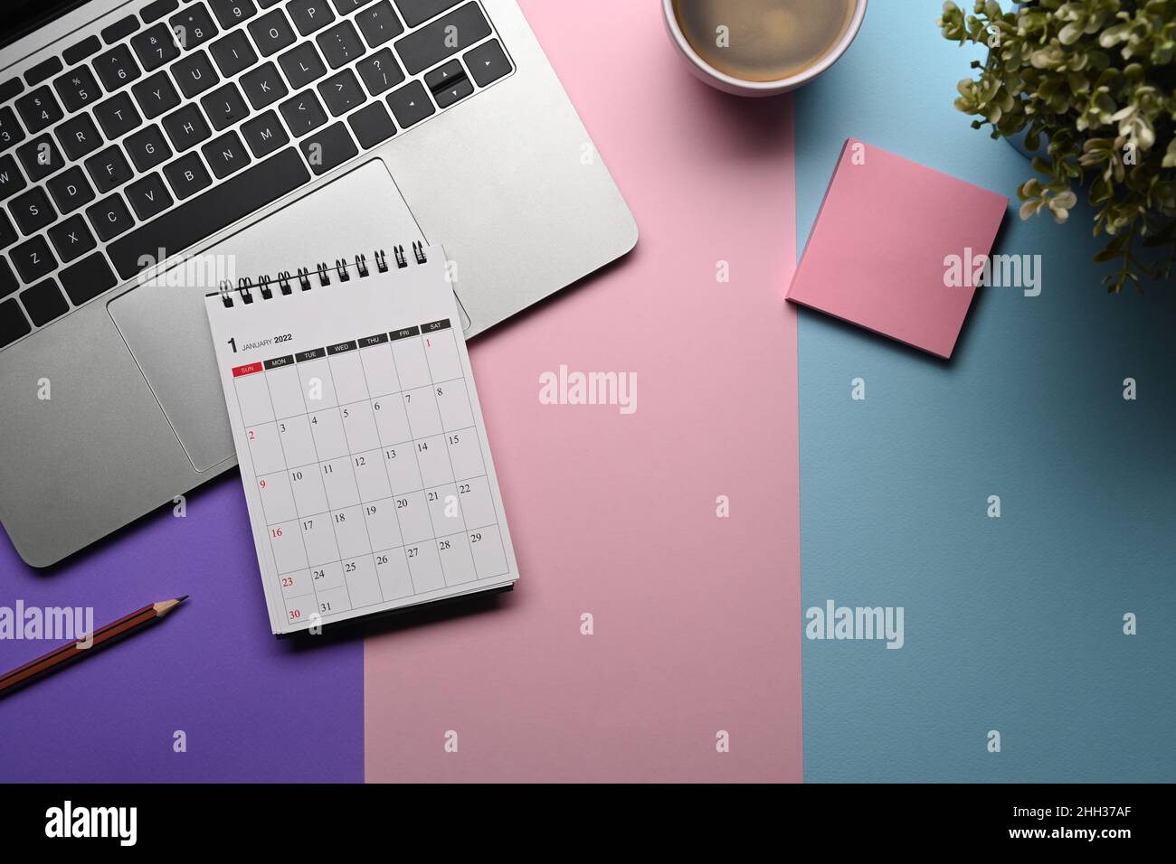 Above view computer laptop, calendar, sticky note and coffee cup on ...