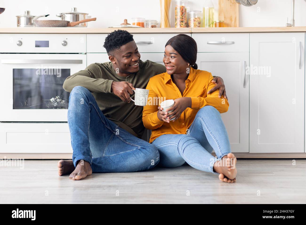 Romantic Black Millennial Couple Relaxing With Coffee In Kitchen