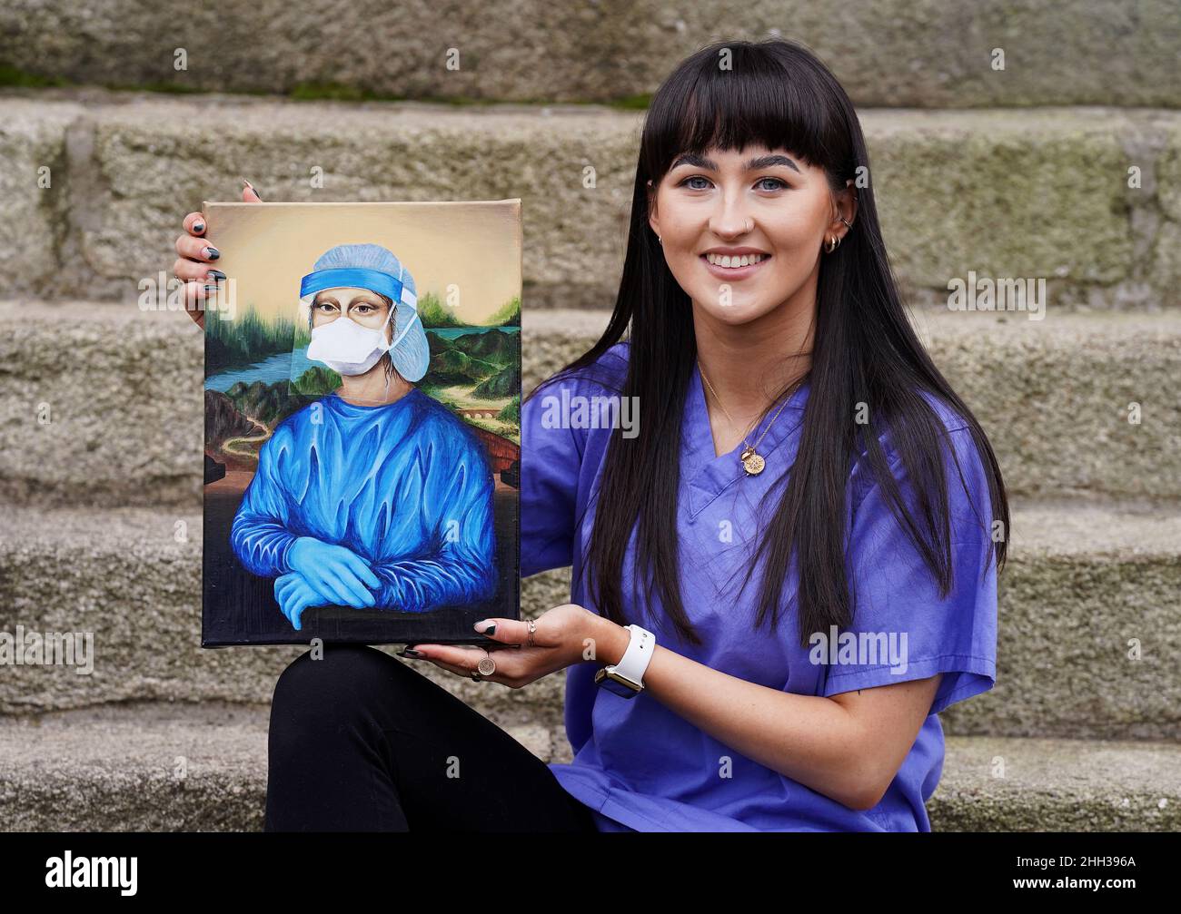 Trainee nurse Chloe Slevin, with her painting 'Corona Lisa' showing ...