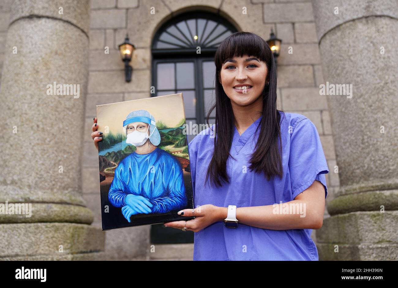 Trainee nurse Chloe Slevin, with her painting 'Corona Lisa' showing ...