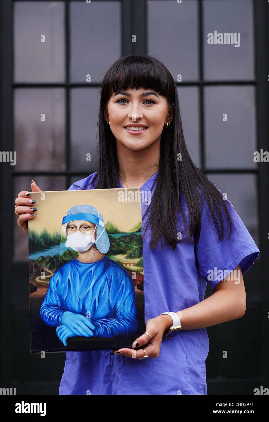 Trainee nurse Chloe Slevin, with her painting 'Corona Lisa' showing ...