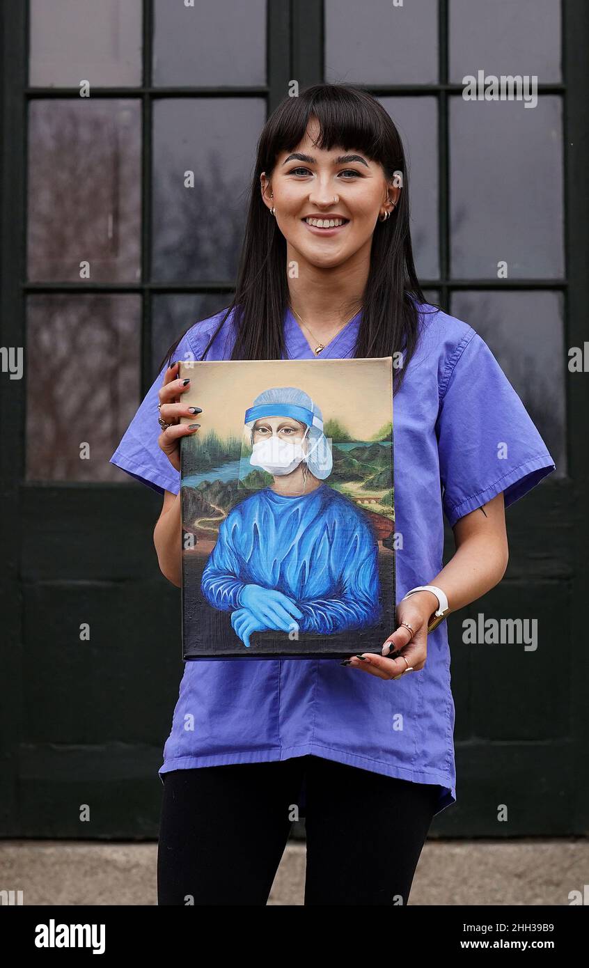 Trainee nurse Chloe Slevin, with her painting 'Corona Lisa' showing ...
