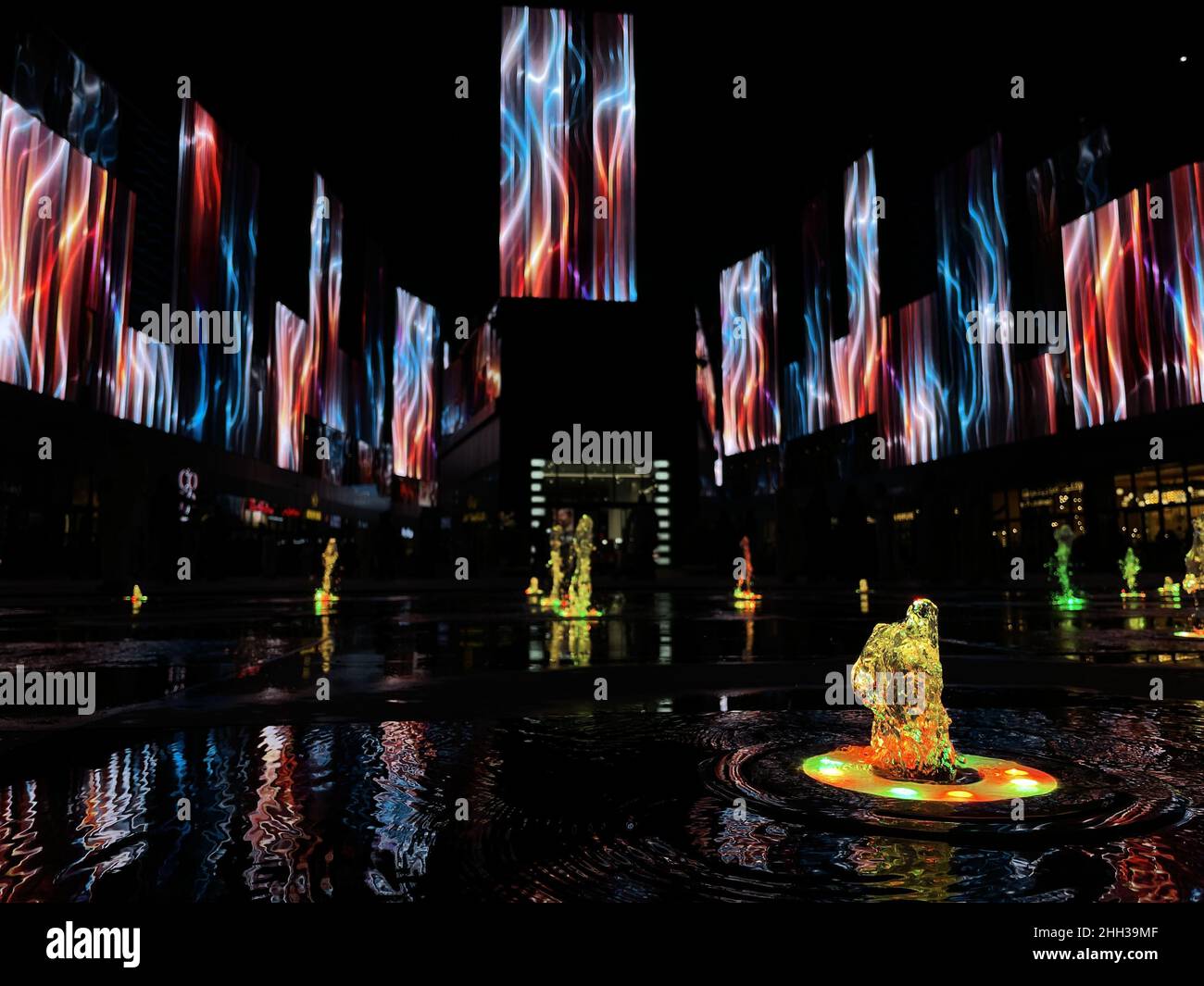 Reflection of colors on water fountains and screens that display ...