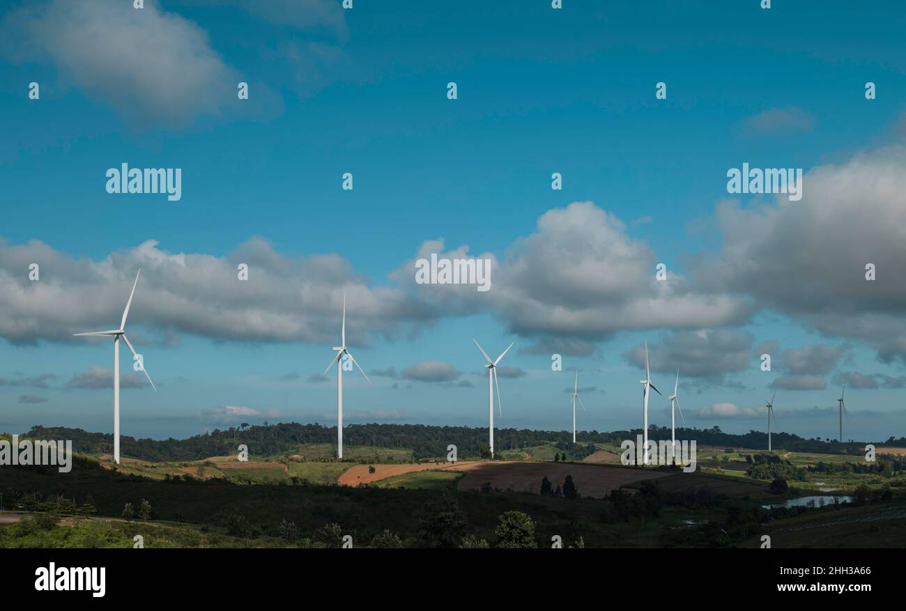 Eco power, landscape with hills and wind turbine field on blue sky ...
