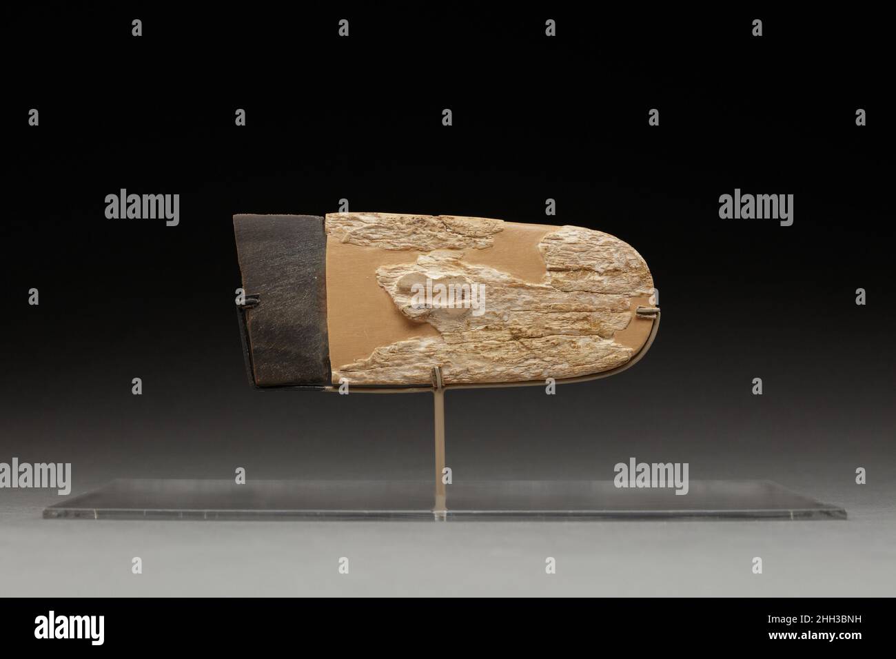 Carved handle of a ceremonial knife with part of the ripple-flaked ...