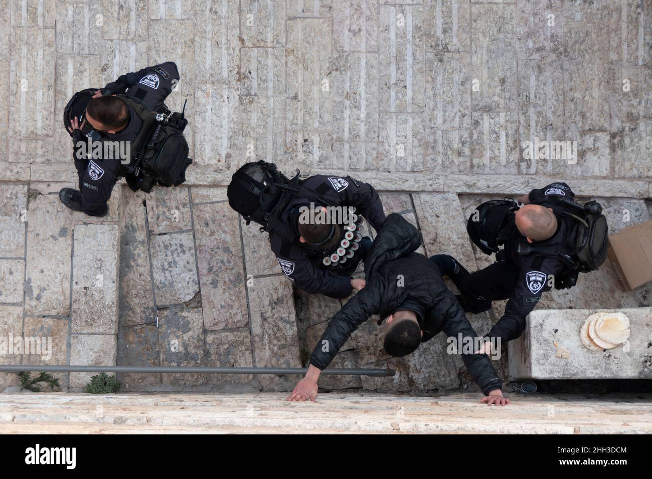 Members of the Israeli Security Forces perform a body search on a young ...