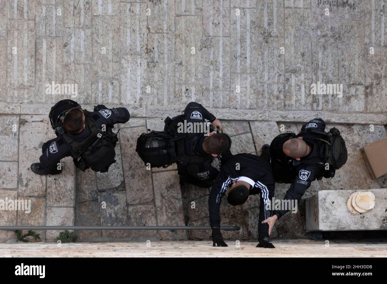 Members of the Israeli Security Forces perform a body search on a young ...