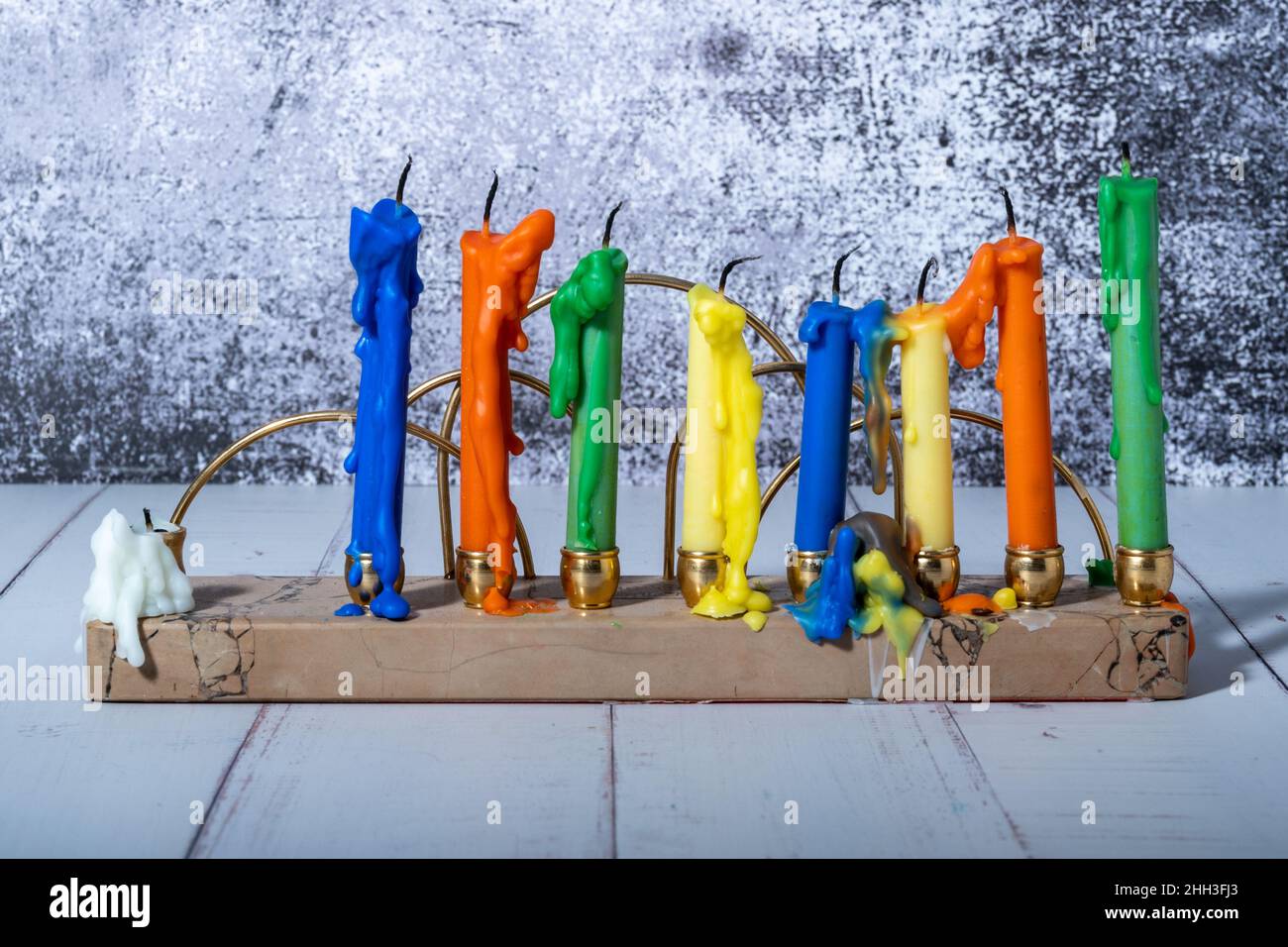 Candlestick with multi-colored candles on the background of a light ...