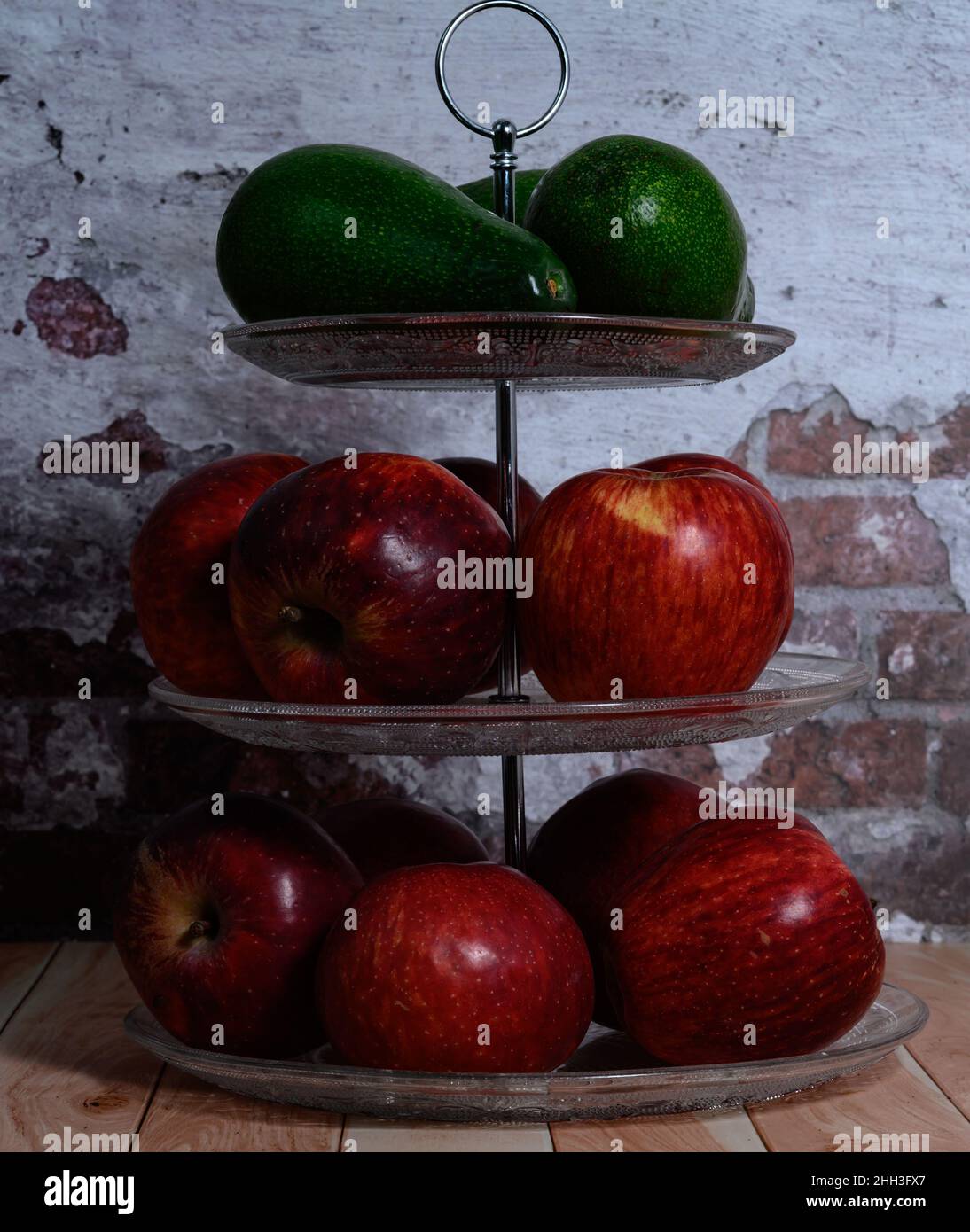 3 tier round glass fruit plates with red apples close-up Stock Photo ...