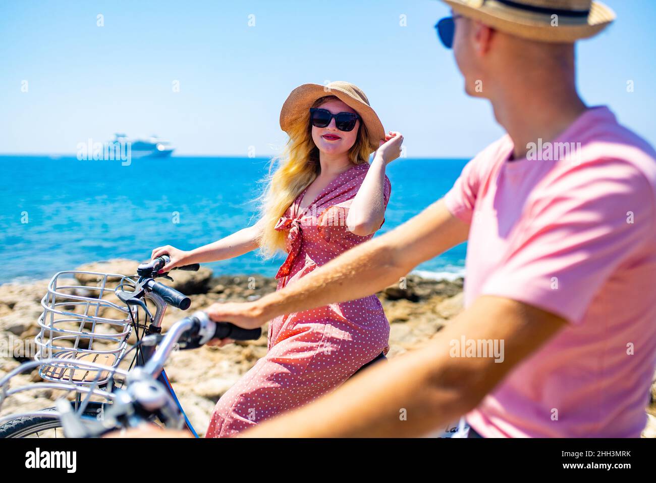 Happy Adult People Cheerful Couple Enjoy The Outdoor Leisure Activity Riding A Bike Seaside
