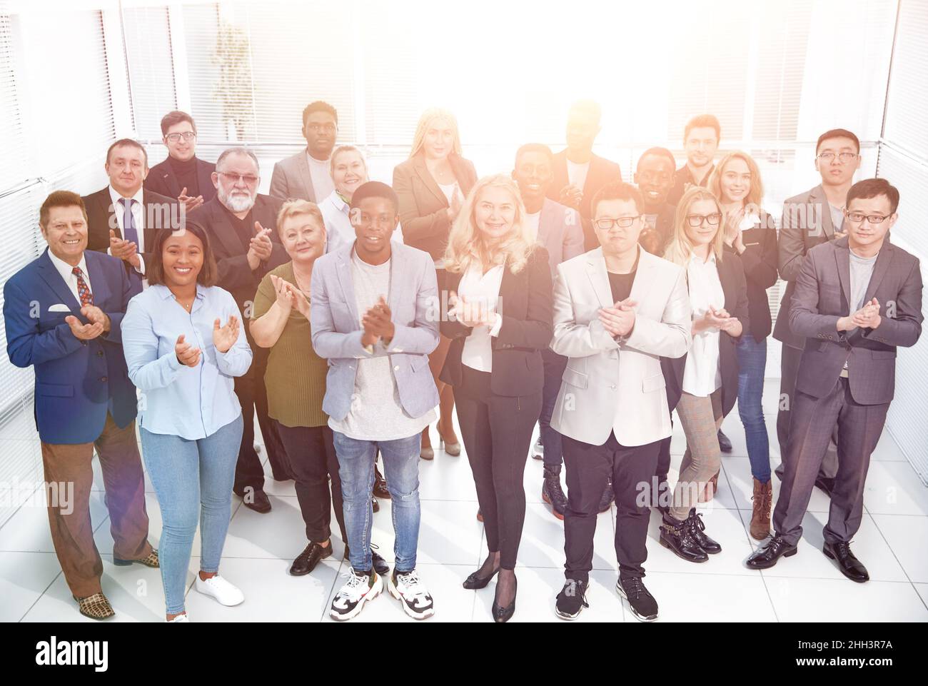 in full growth. group of diverse corporate employees applauding ...