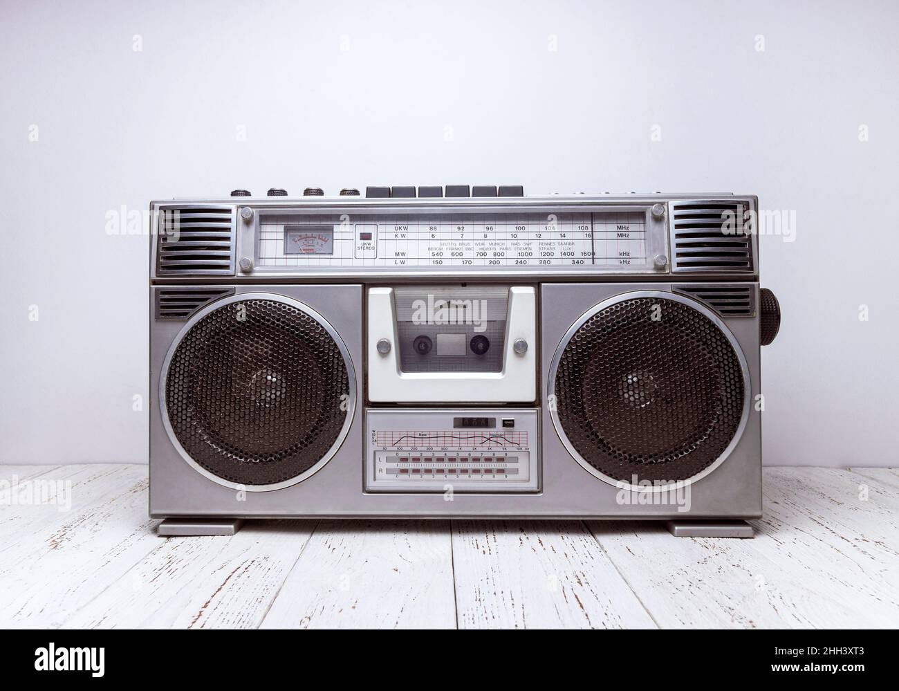 Cassette retro tape recorder stands on a table in front of a white ...
