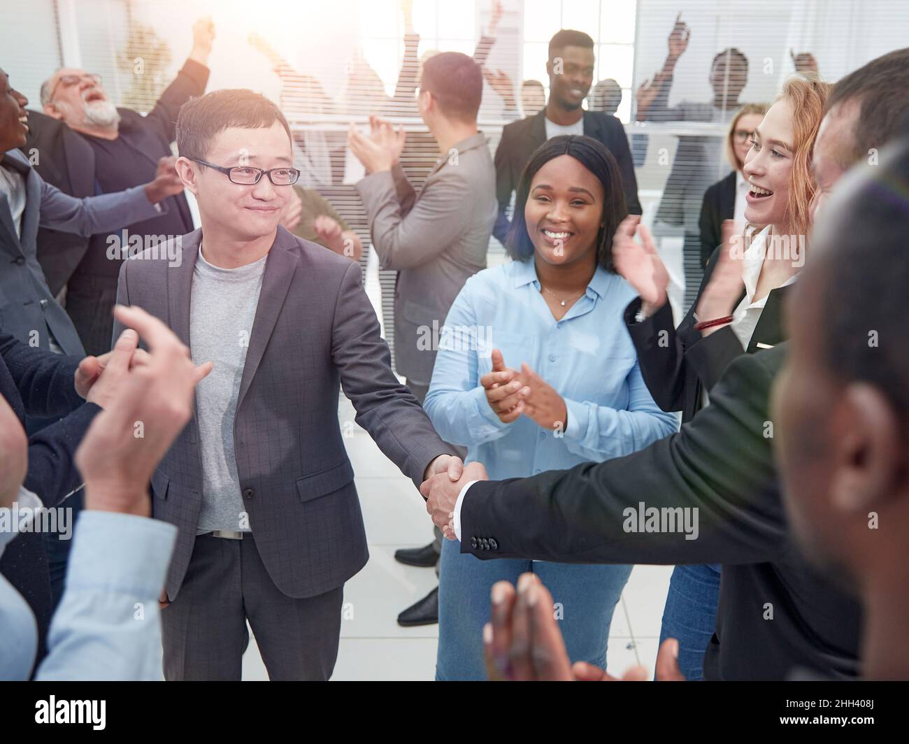 Business people reaching an agreement in an office. Handshake in front ...