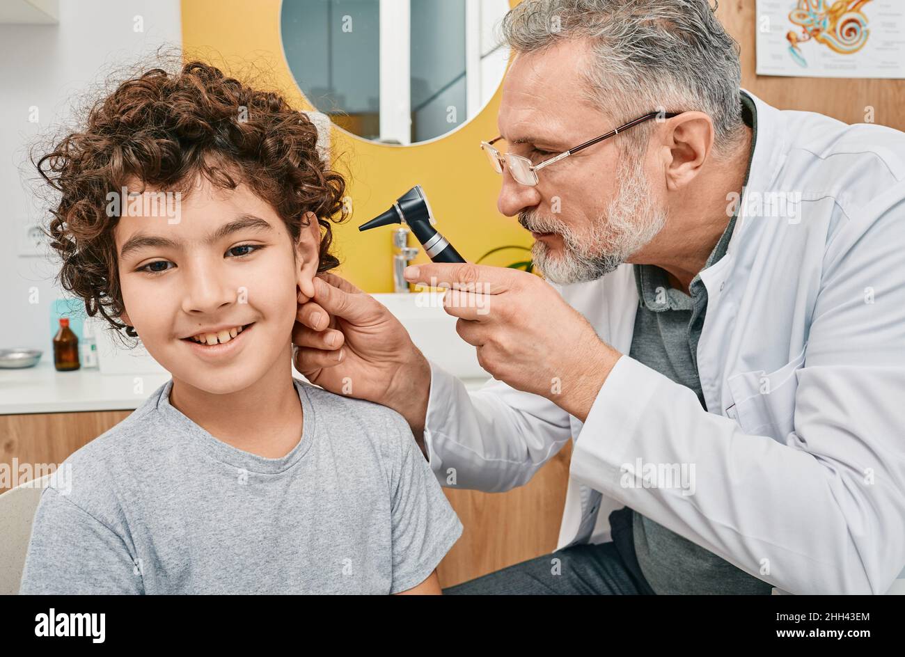 Otoscopy and hearing check-up for boy at audiology office. Pediatrician ...