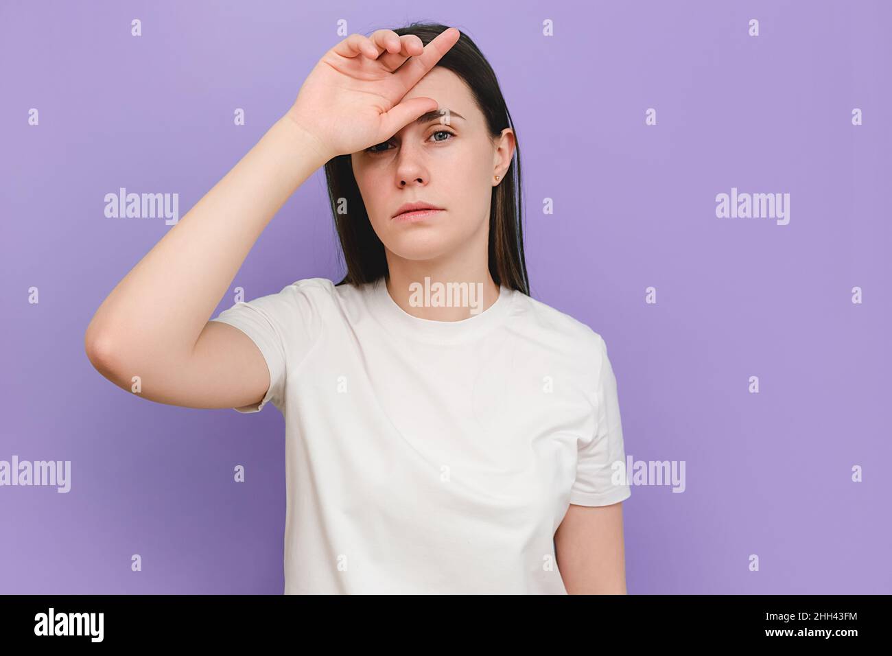 Portrait of unhappy sad young brunette woman suffering from headache ...