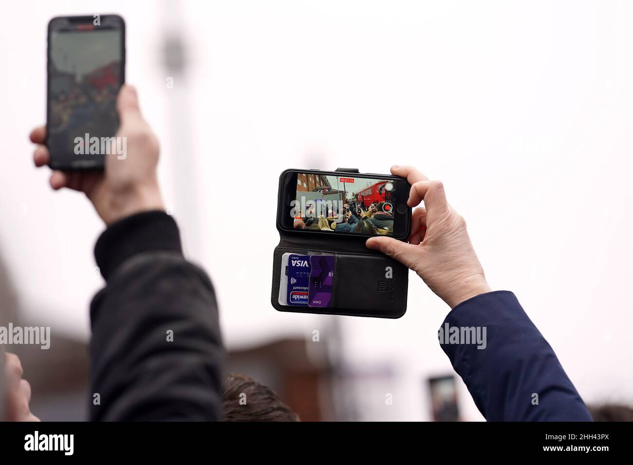 Fans film on their mobile phones as the Liverpool team coach arrives ...