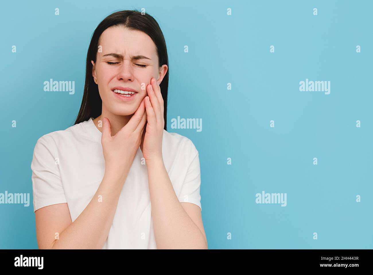 Unhappy sad young caucasian female suffering from acute tooth pain ...