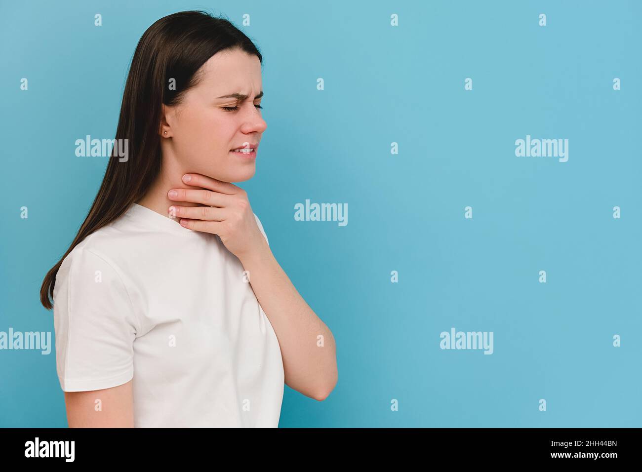 Unhealthy young woman touch neck hard to swallow having discomfort or ...