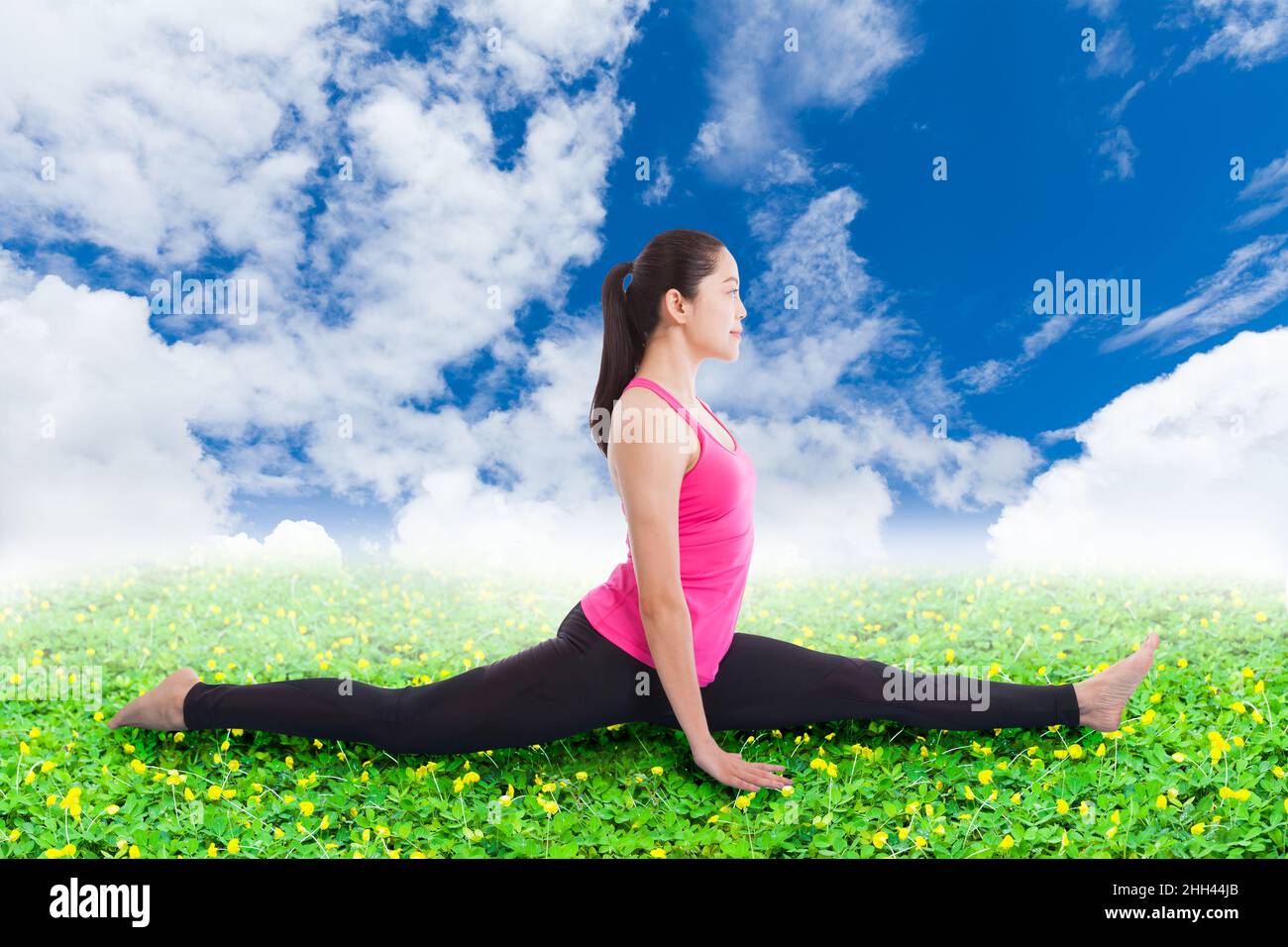 Asian woman practicing yoga exercise called Monkey Pose (Hanumanasana ...