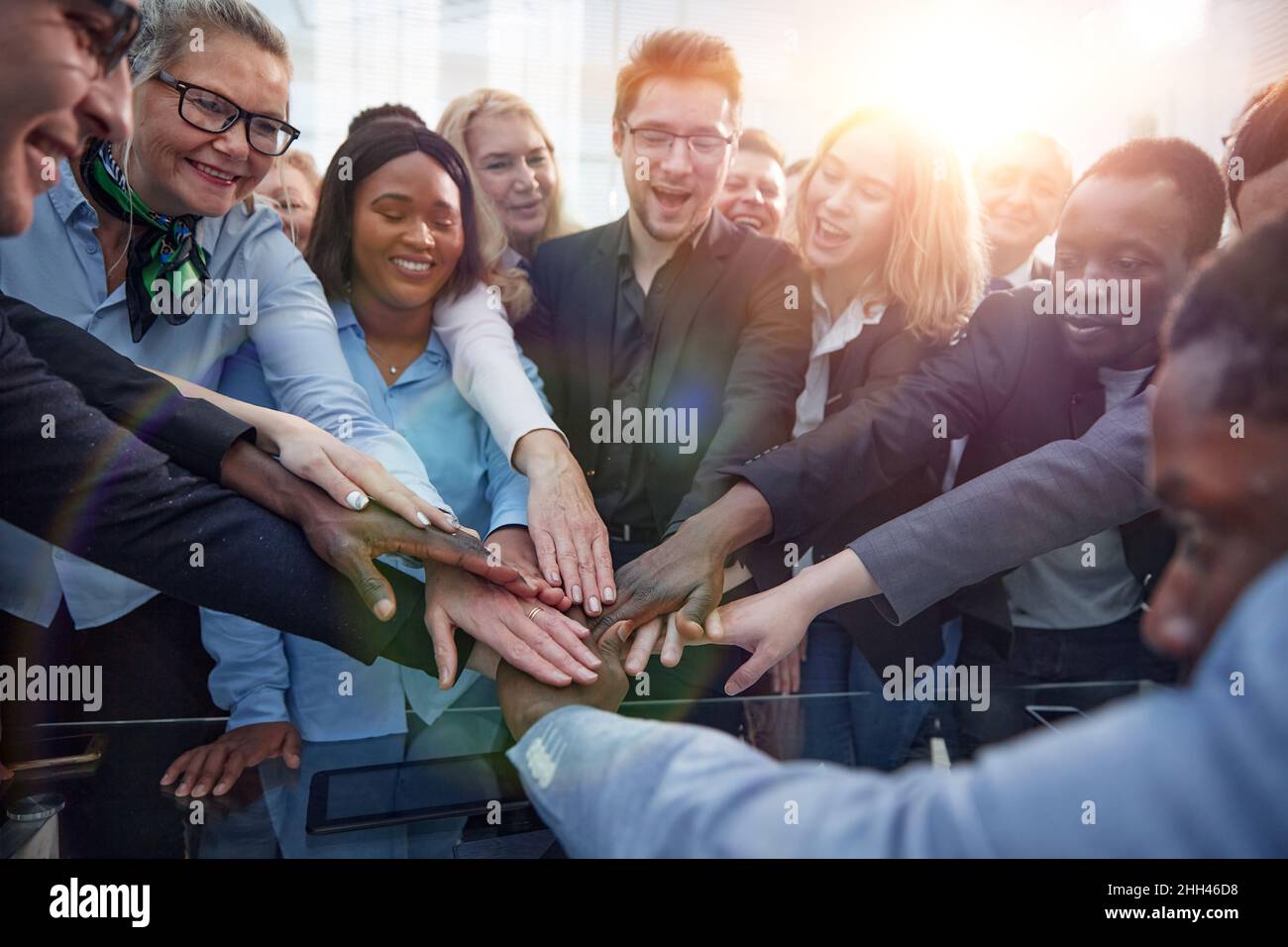 young business people putting their hands together. Stack of hands. Unity and teamwork concept ...
