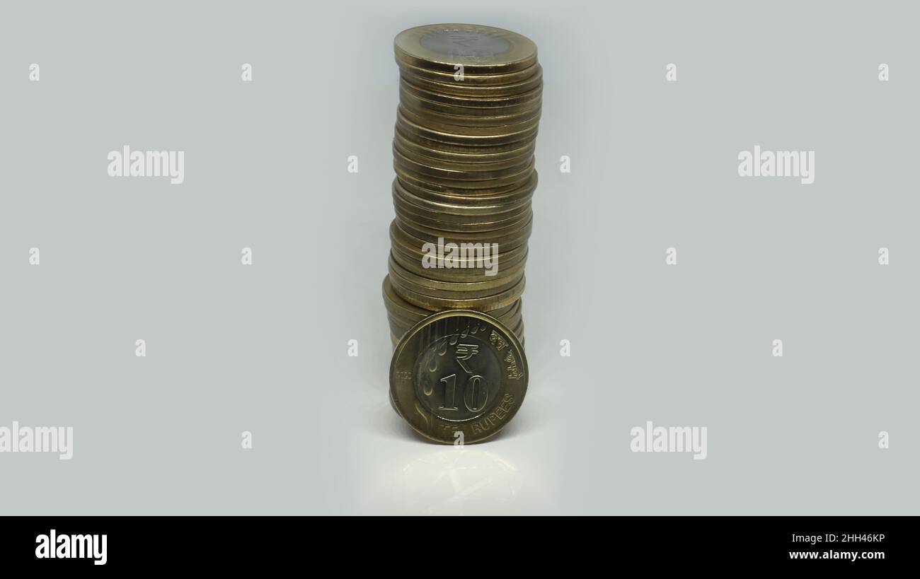Indian Rupee Coins. ten rupees coins stacked vertically. On a white ...