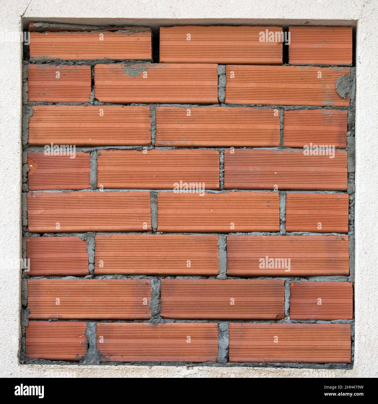 Close up shot of a square window frame blocked by cemented bricks Stock ...