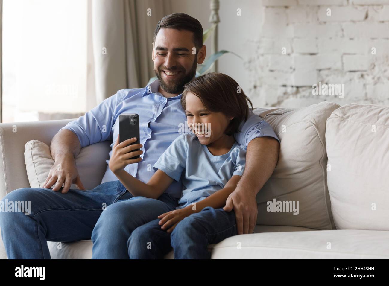 Happy son kid and cheerful dad talking on video call Stock Photo - Alamy