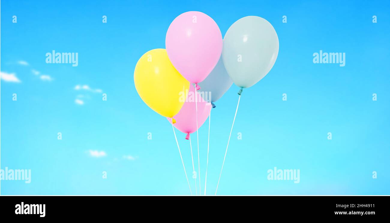 Flying coloured balloon on blurred sky background Stock Photo - Alamy