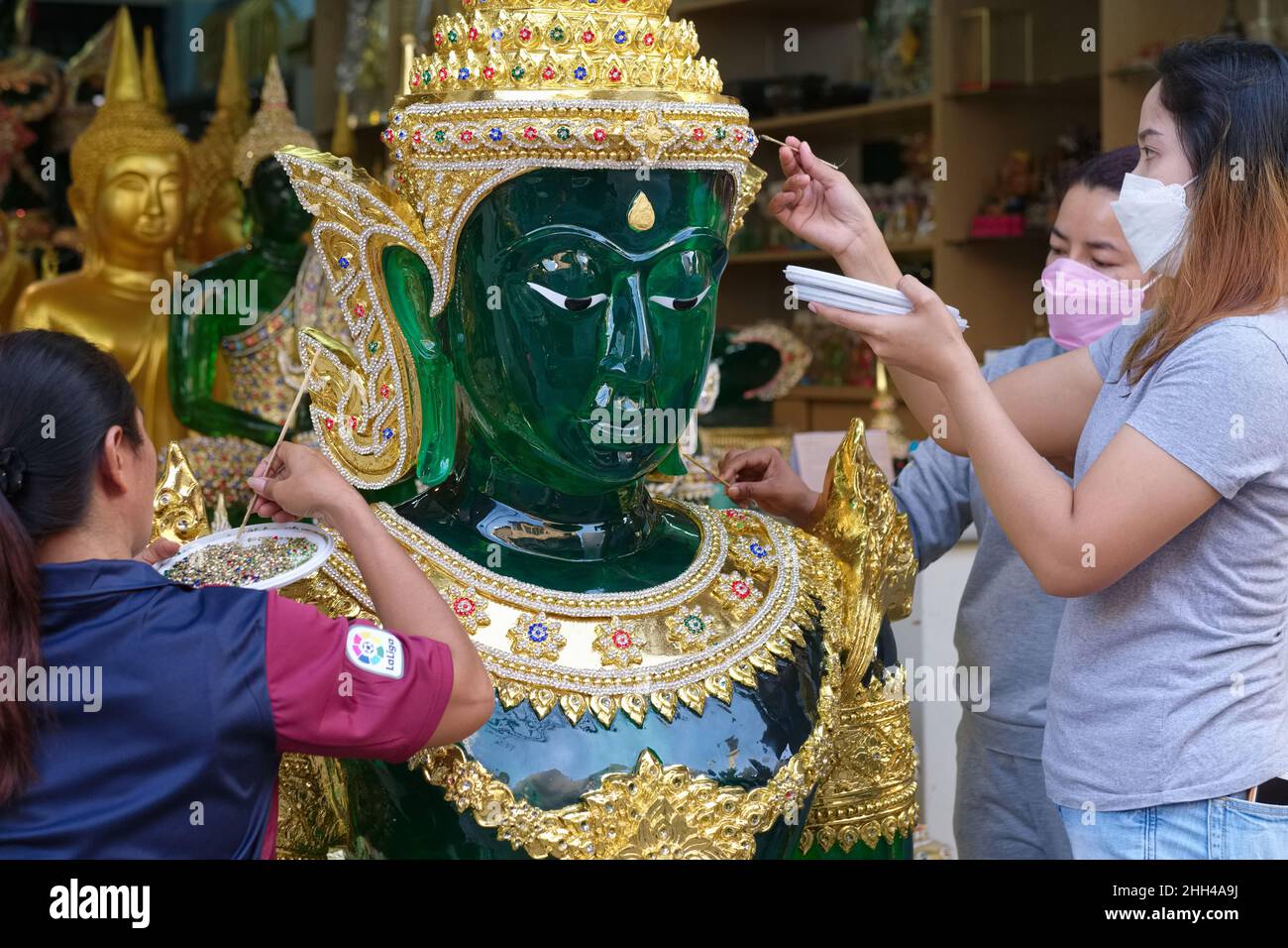 Employees in a workshop for Buddhist ritual objects in Bamrung Muang Rd ...